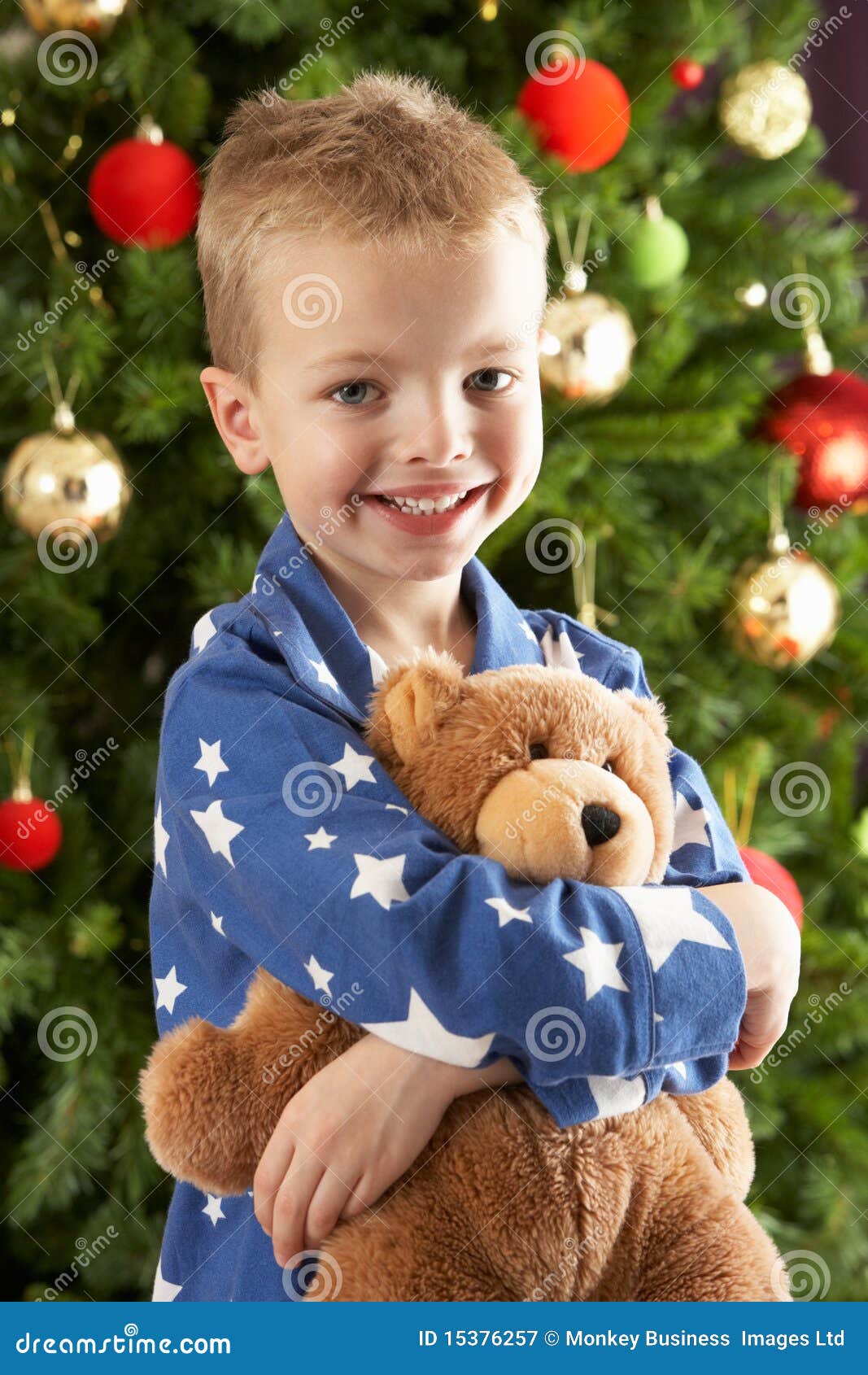 Young Boy Cuddling Teddy Bear in Front of Tree Stock Image - Image of ...