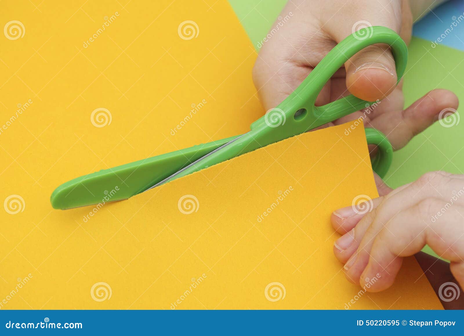 A young boy cutting paper stock image. Image of green - 50220595