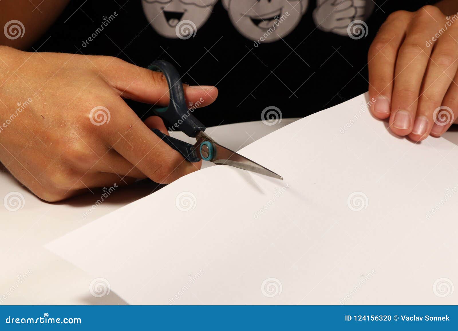A Young Boy Cutting Paper with Scissors at School for Some Exam. Stock ...