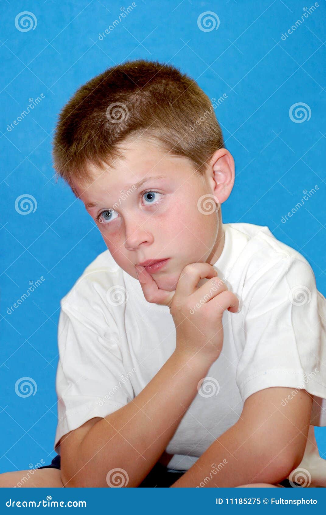 Young boy in deep thought stock image. Image of engrossed - 11185275