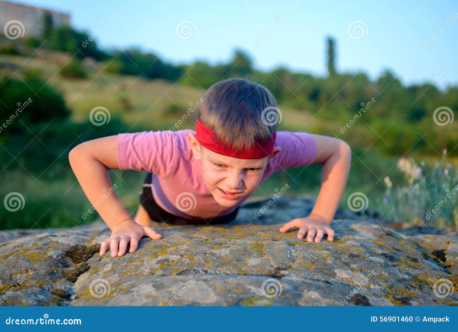 Young Boy Doing Push-ups on a Rock Stock Photo - Image of active ...