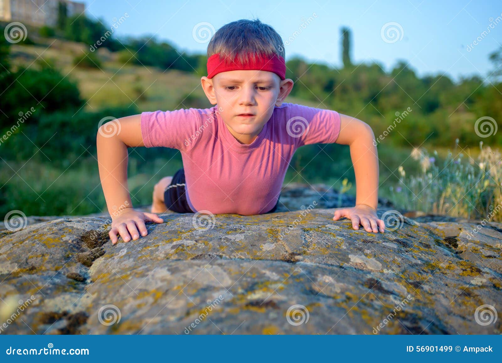 Young Boy Doing Push-ups on a Rock Stock Image - Image of child, summer ...