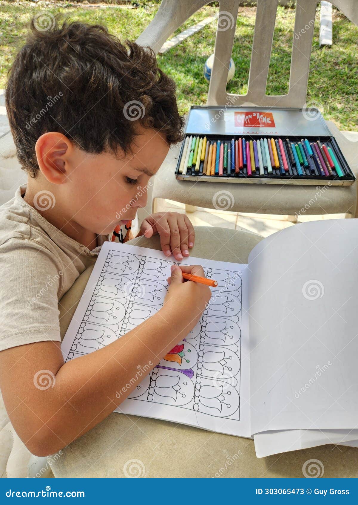 Young Boy Drawing with Crayons on a Piece of Paper. Stock Image - Image ...