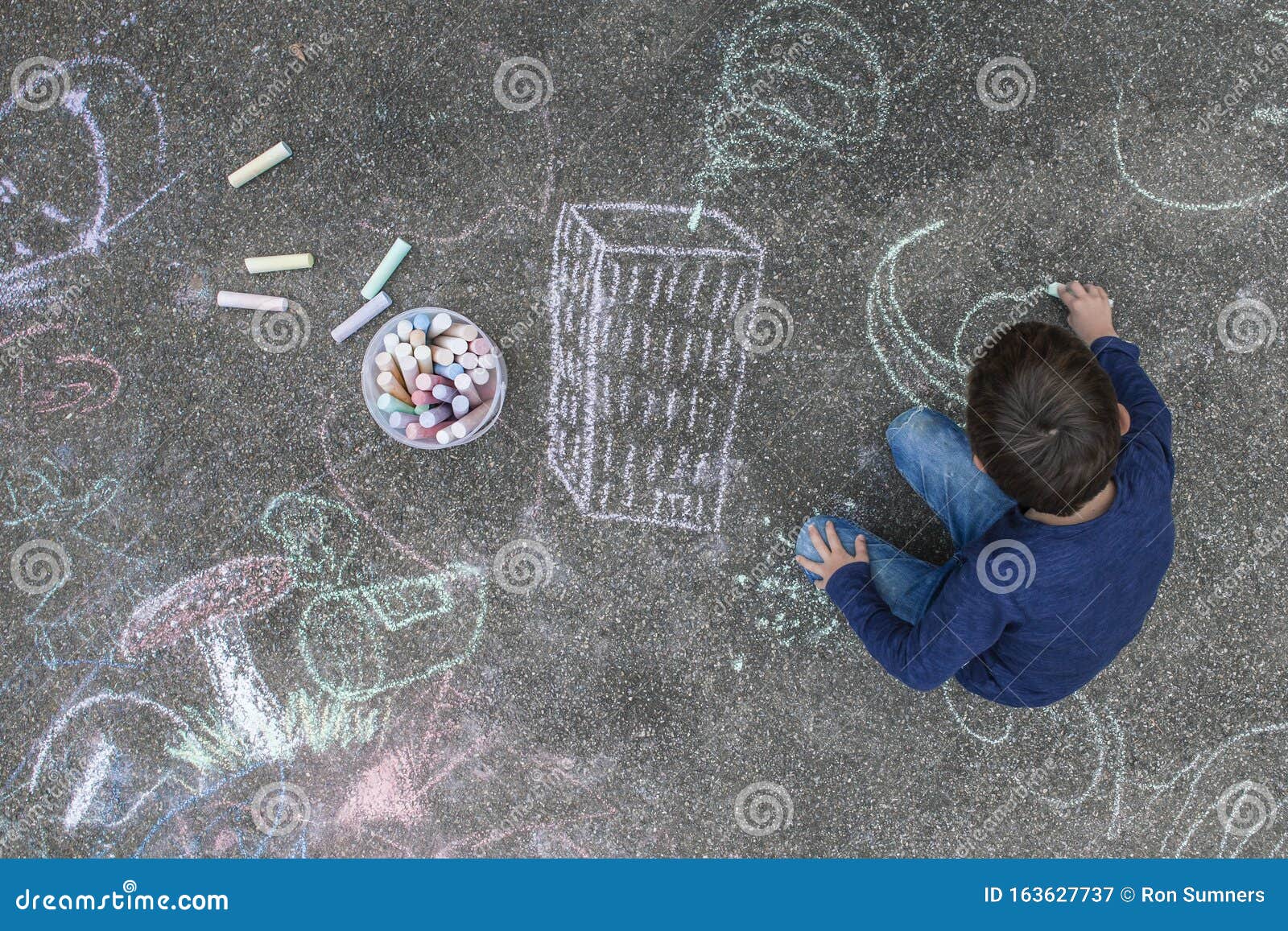 Young Boy Drawing On The Sidewalk With Chalk Royalty-Free Stock Photo ...