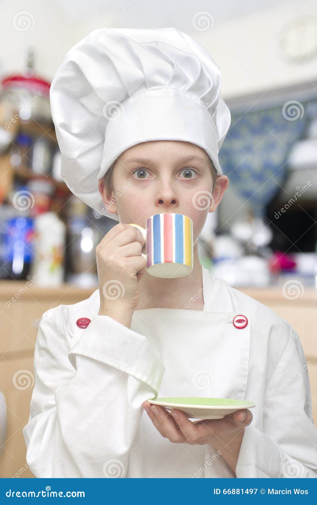 Young Boy Dressed As Chef Drinking Tea in Kitchen. Stock Image - Image ...