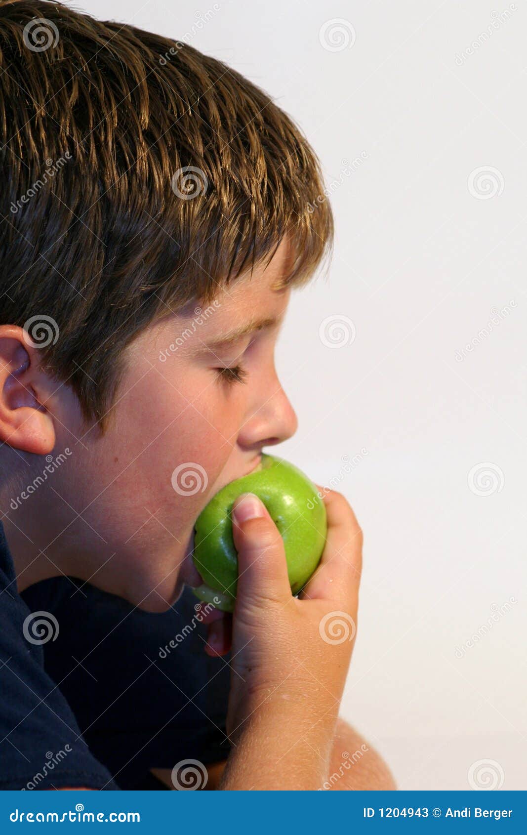 Young boy eating an apple stock image. Image of youth - 1204943