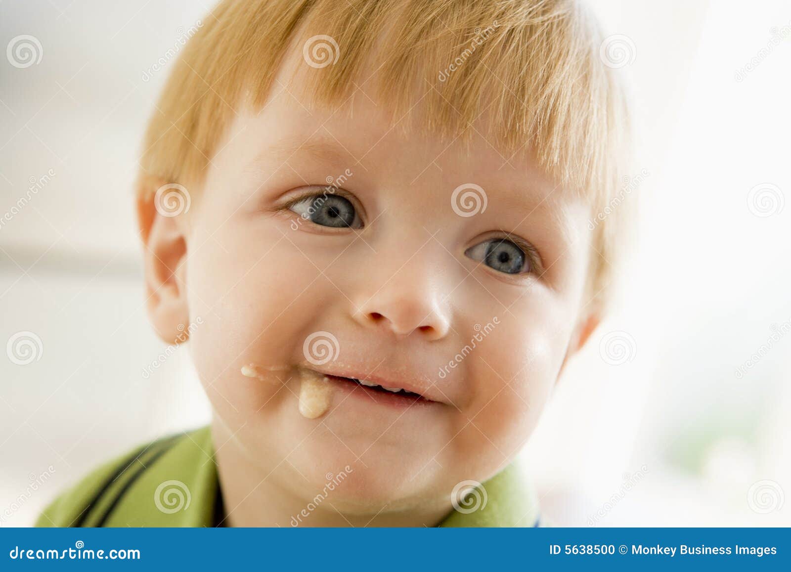 Young Boy Eating Baby Food with Mess on Face Stock Photo - Image of ...