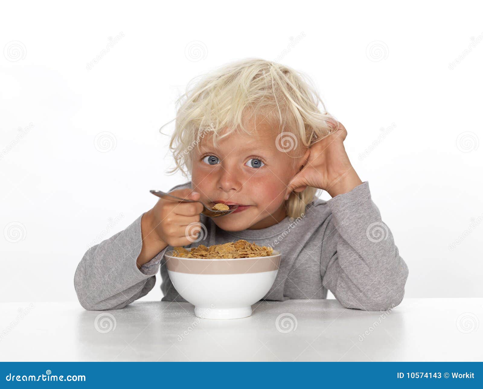 Young boy eating breakfast stock image. Image of eyed - 10574143