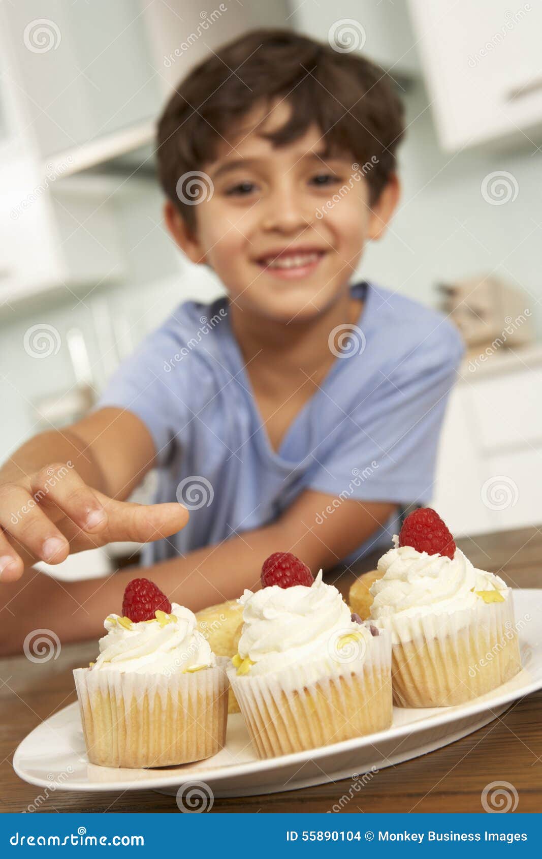Young Boy Eating Cakes in Kitchen Stock Photo - Image of cake, enjoying ...
