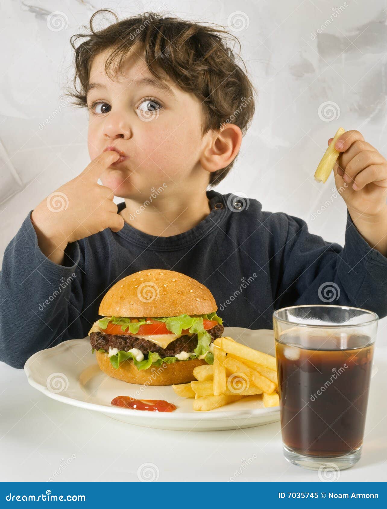 Young Boy Eating Chessburger Stock Image - Image of lettuce, food: 7035745