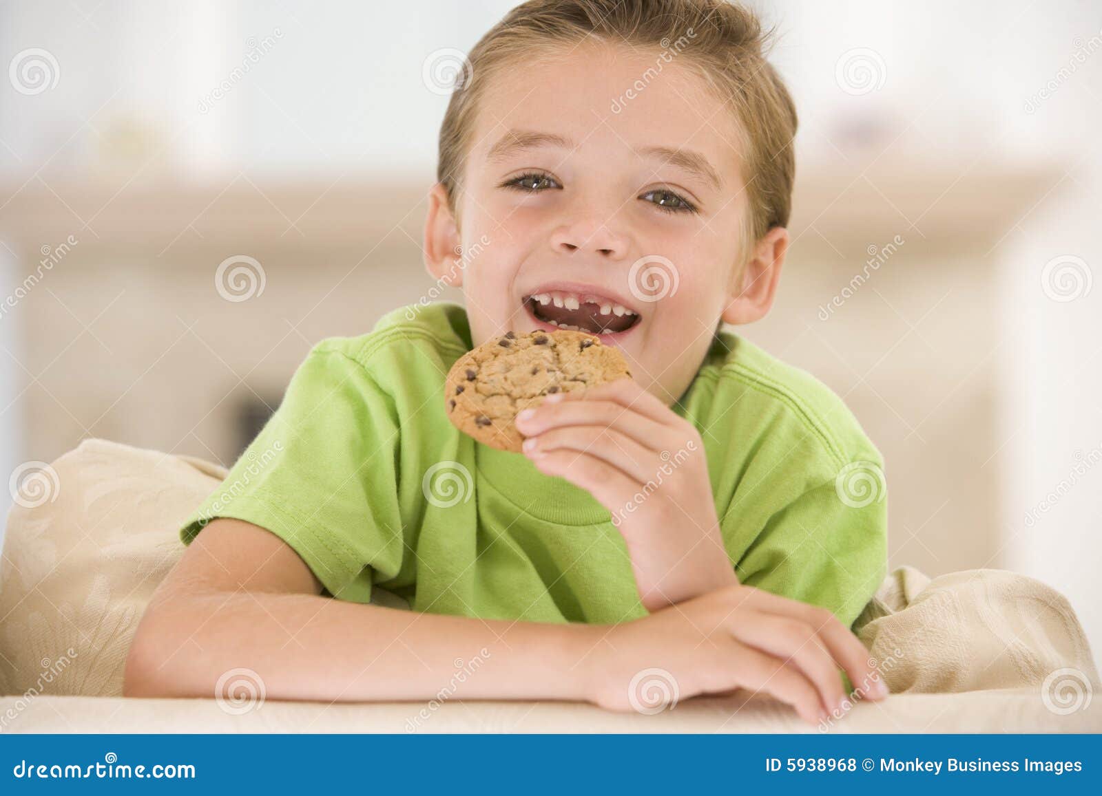 Young Boy Eating Cookie in Living Room Smiling Stock Photo - Image of ...