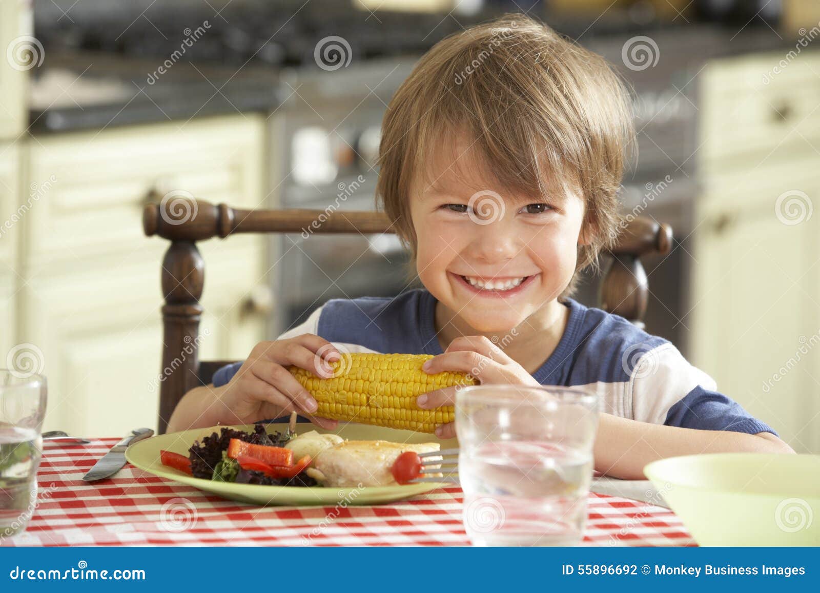 Young Boy Eating Meal in Kitchen Stock Photo - Image of indoors, person ...