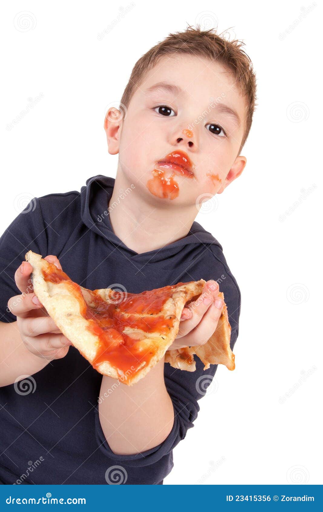 A Young Boy Eating Pizza Royalty Free Stock Image - Image: 23415356
