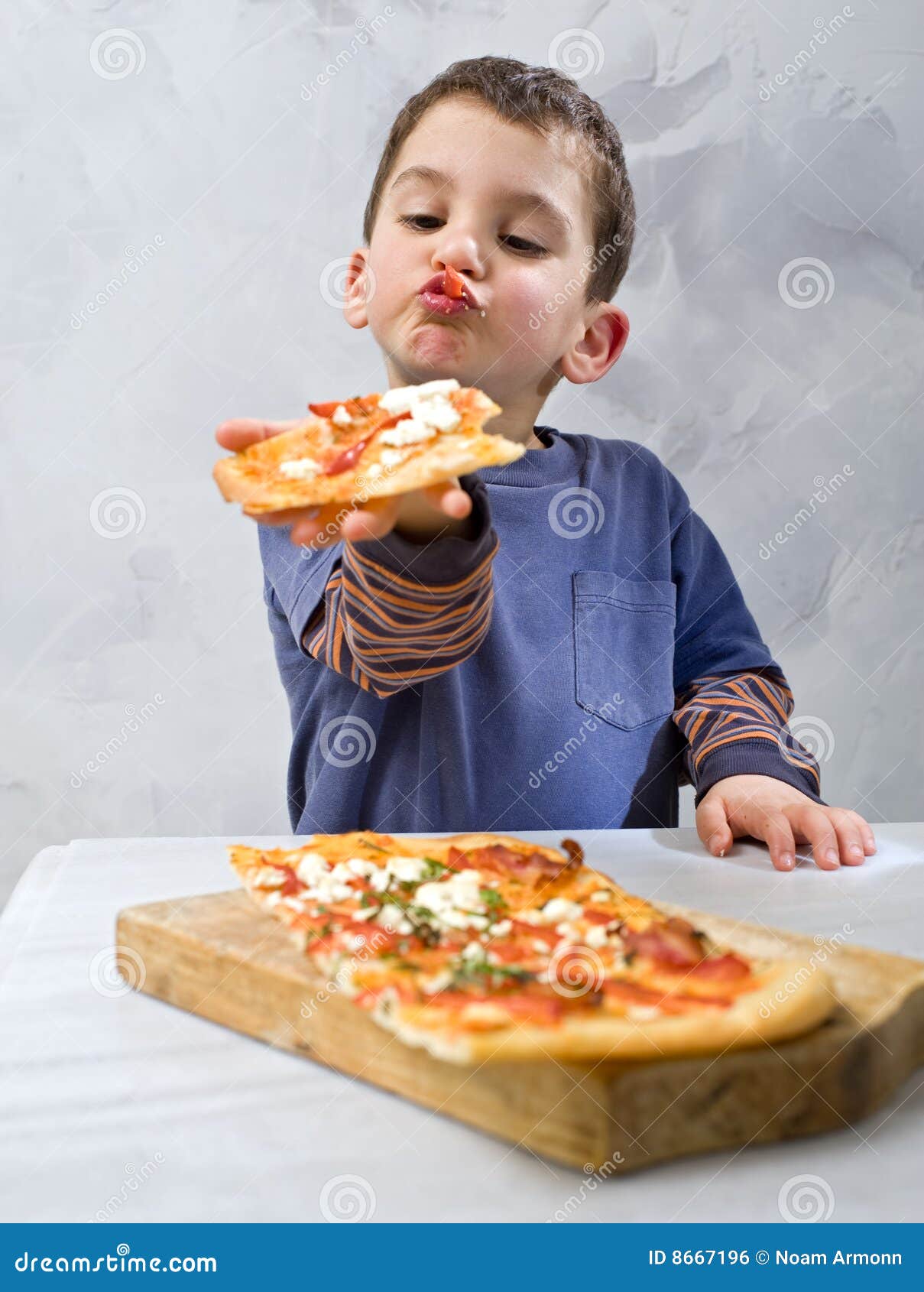 Young boy eating pizza stock photo. Image of anticipation - 8667196