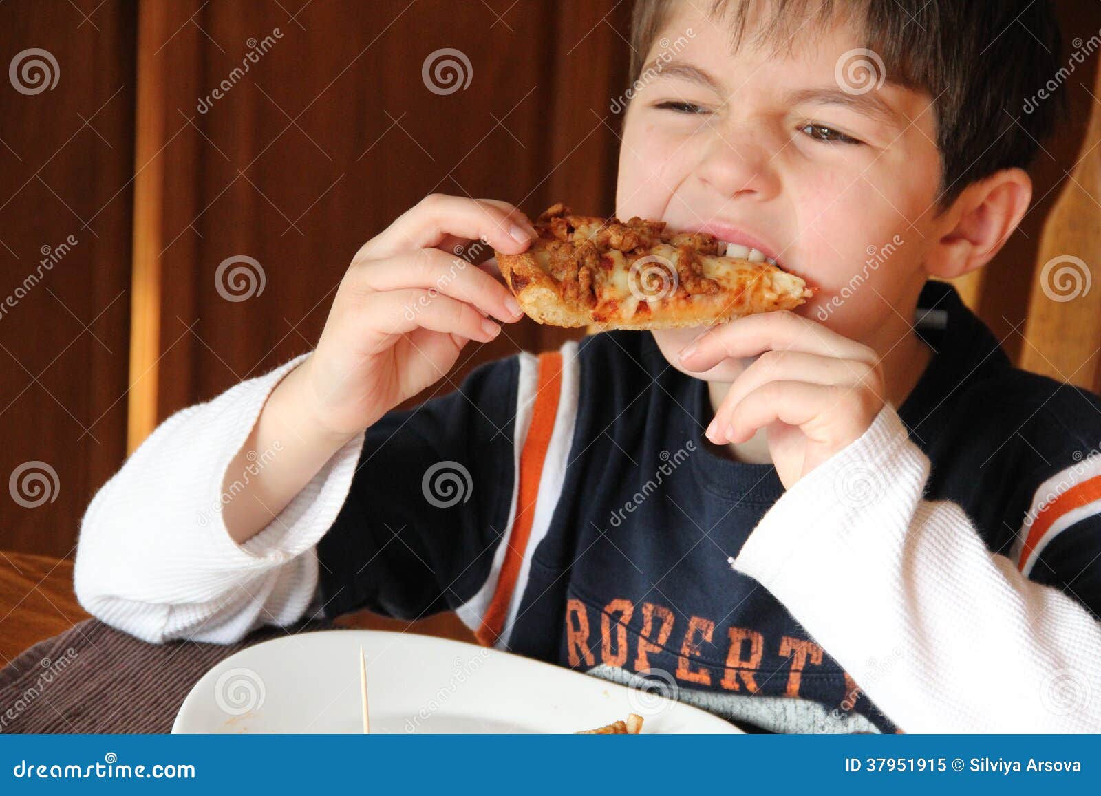 Young Boy eating Pizza stock image. Image of hand, hungry - 37951915