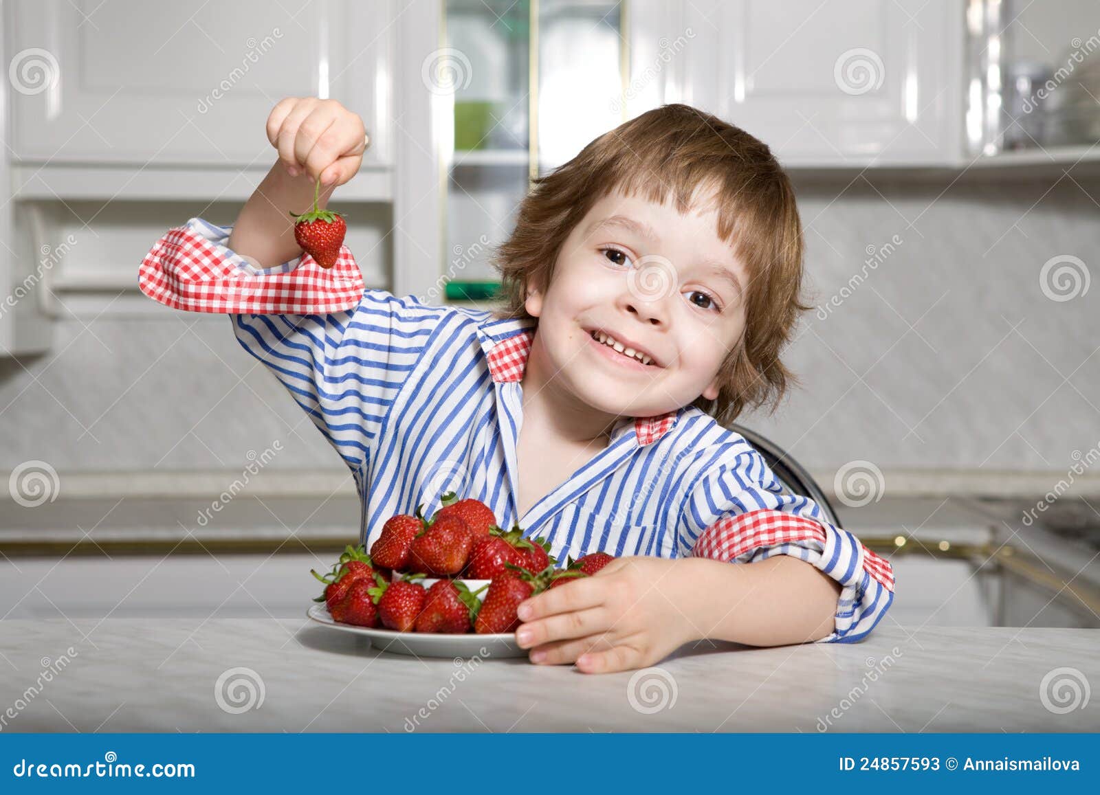 Young Boy Eating Strawberry in Kitchen Stock Image - Image of food ...