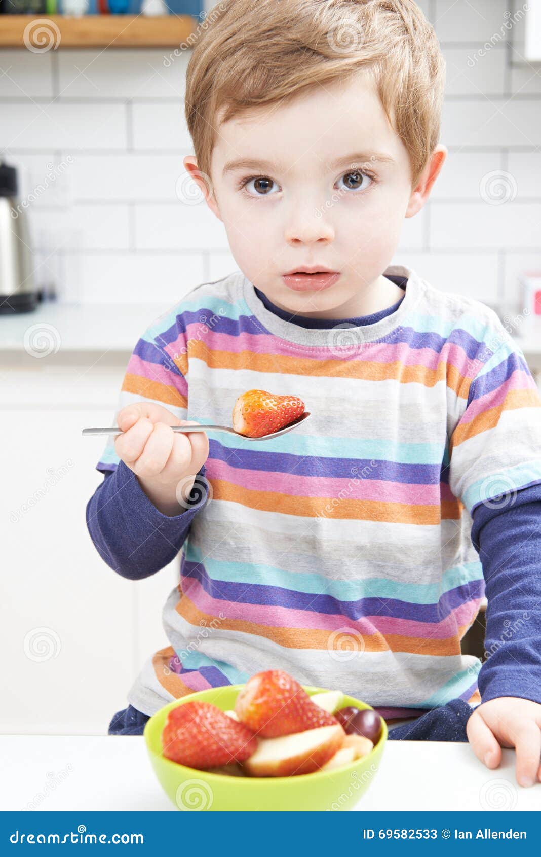 Young Boy Enjoying Healthy Snack of Fresh Fruit Stock Image - Image of ...