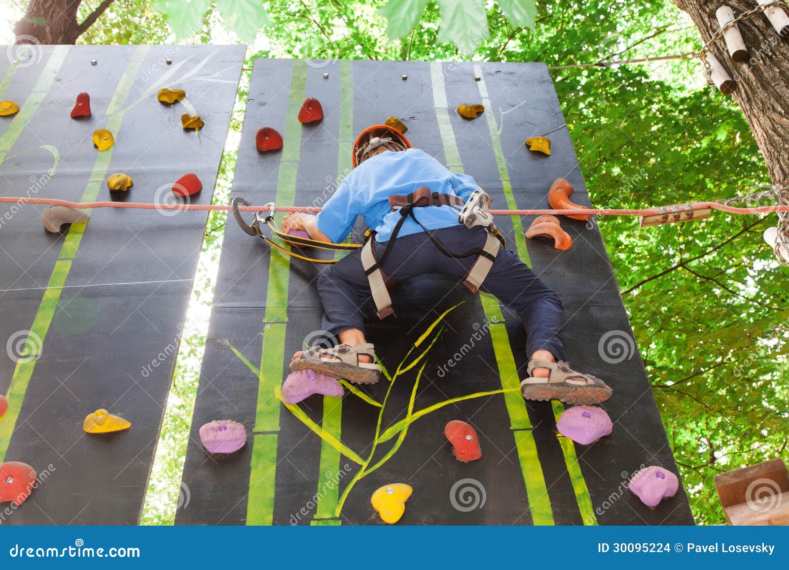 Boy with Equipment Climber Moves Up on Climbing Wall Stock Photo ...