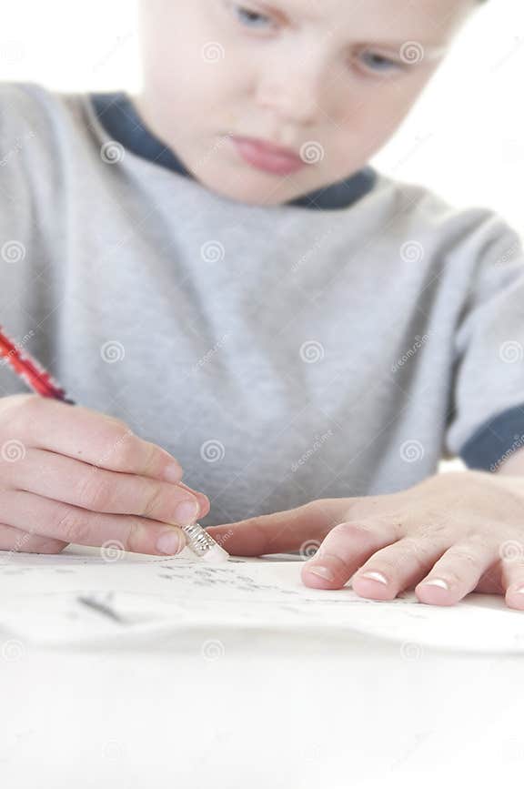 Young boy erasing mistake stock photo. Image of work - 17794406