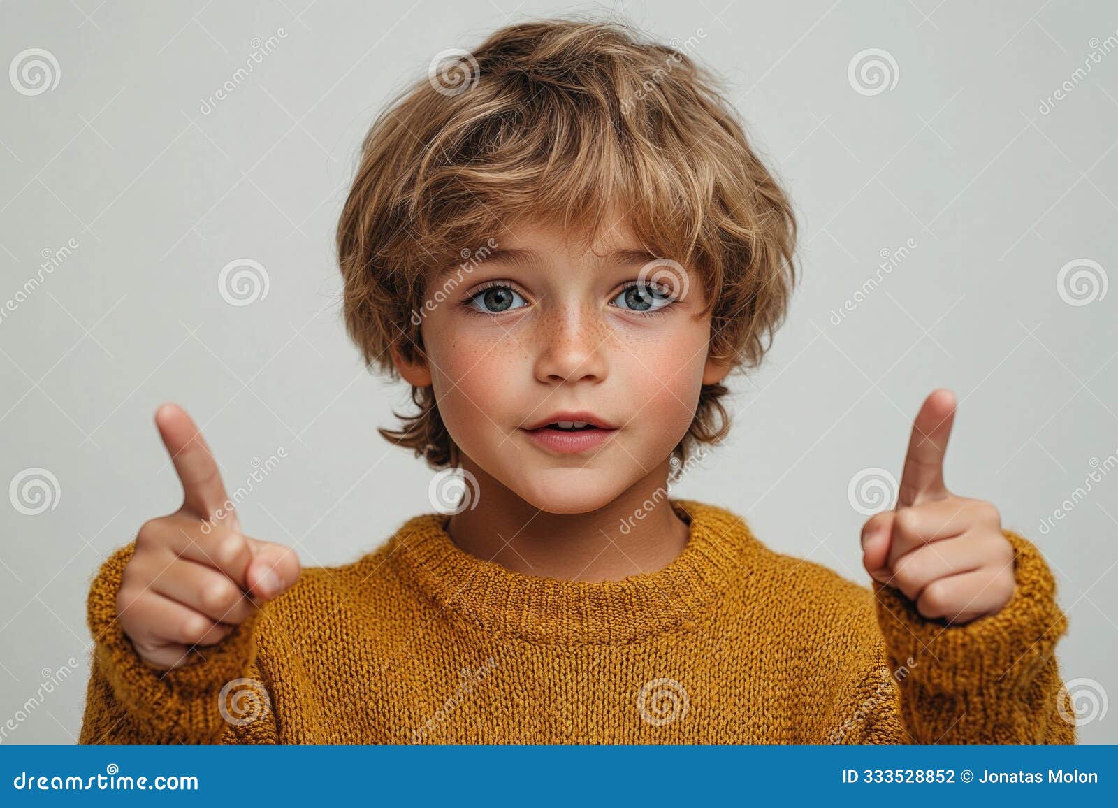 Young Boy Excitedly Pointing at Empty Space with Wonder on His Face Aga ...