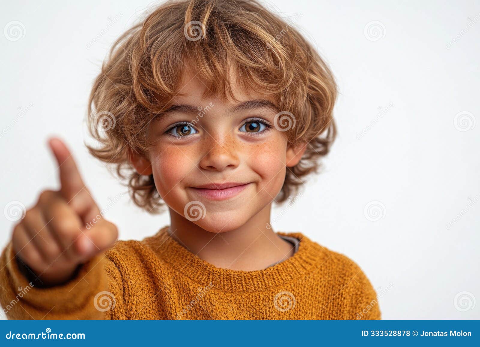 Young Boy Excitedly Pointing at Empty Space with Wonder on His Face Aga ...