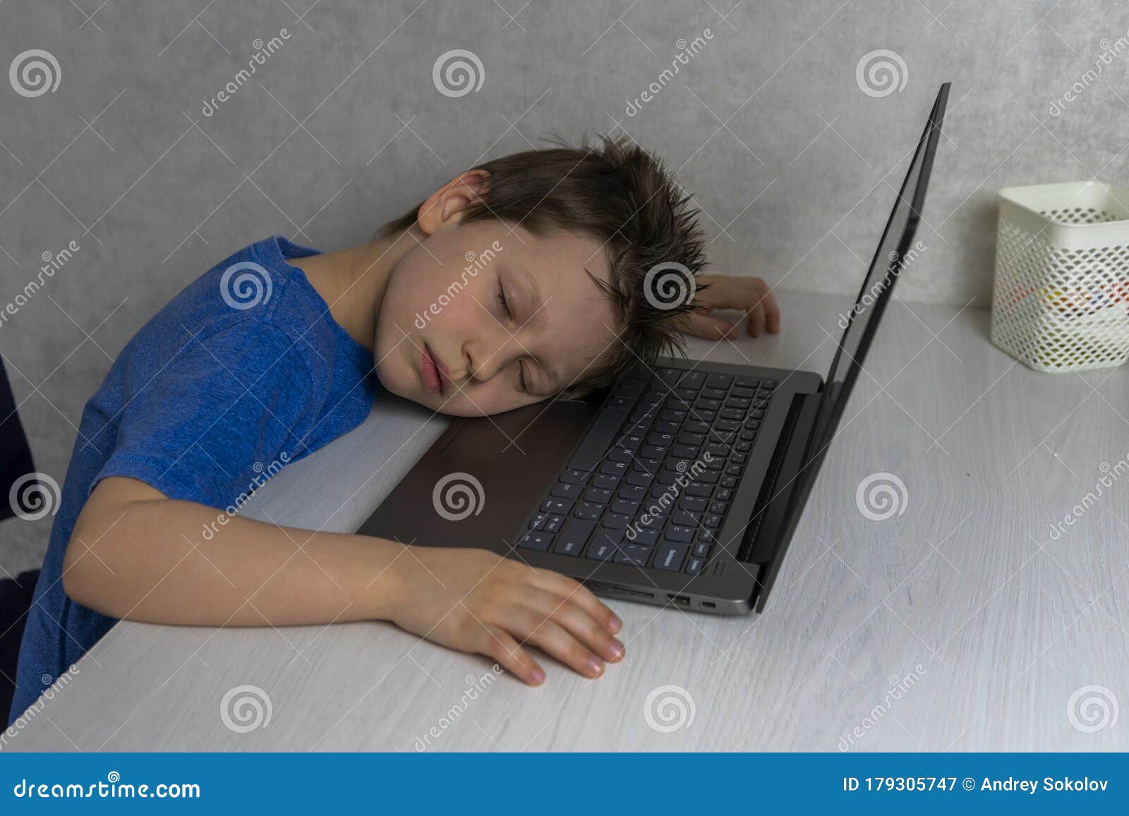 A Young Boy Fell Asleep on a Laptop at a Table Stock Image - Image of ...