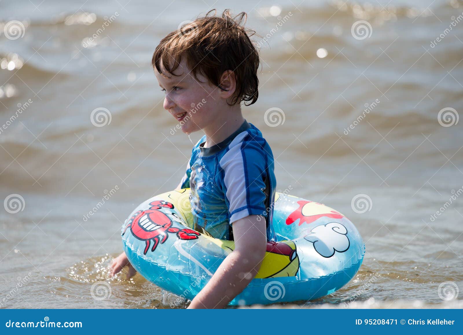 Young Boy Floating in Inner Tubes in a Blissful State Stock Image ...