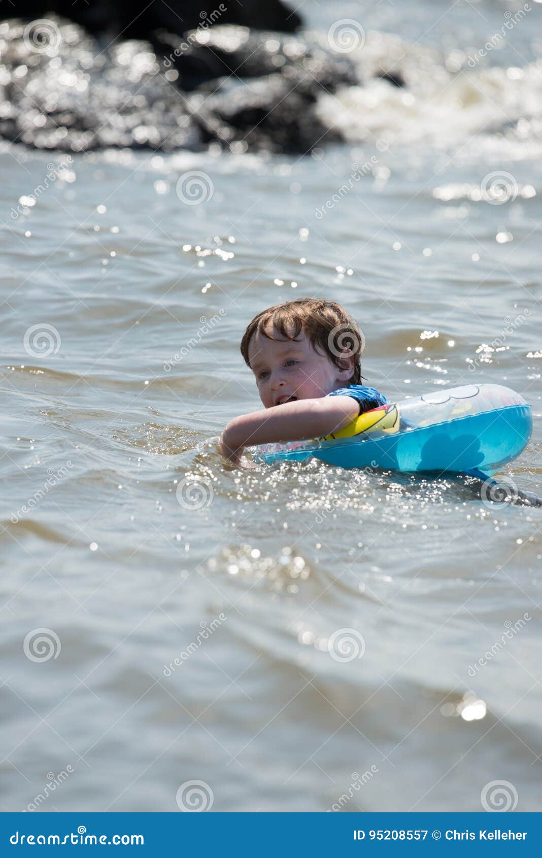 Young Boy Floating in Inner Tubes in a Blissful State Stock Image ...