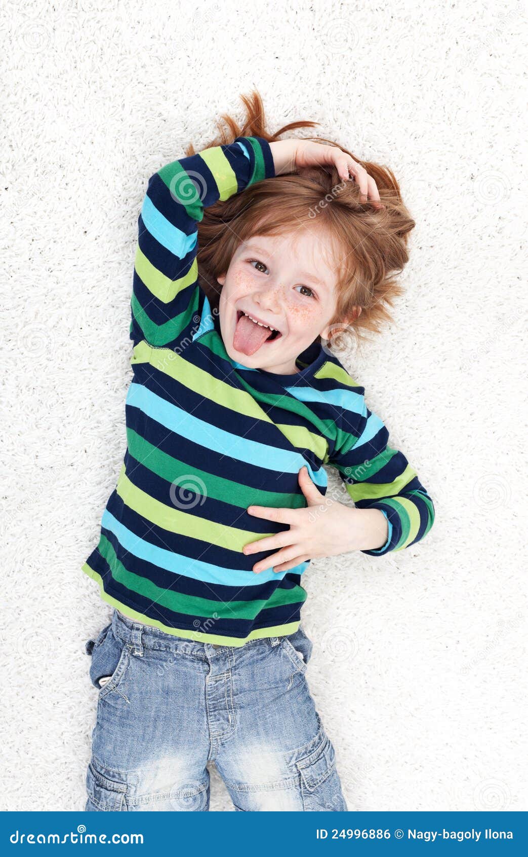 Young Boy Fooling Around and Playing on the Floor Stock Photo - Image ...