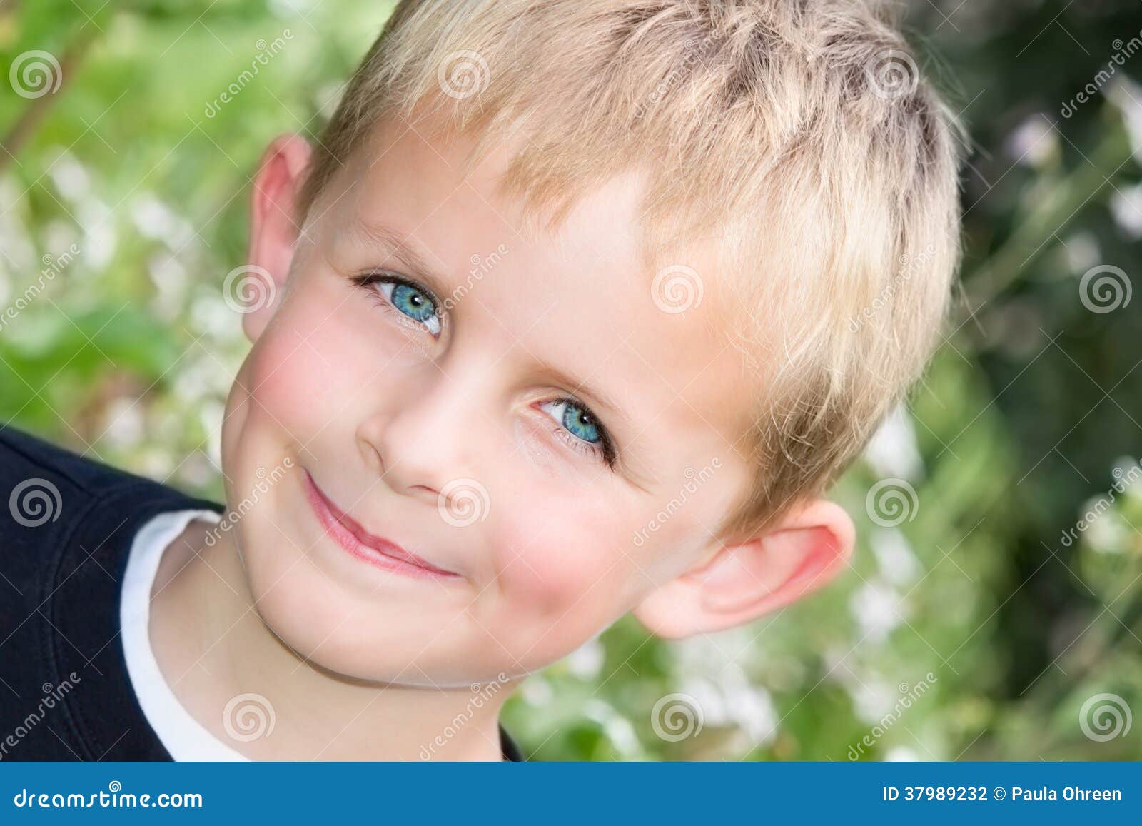 Young Boy Grinning in the Garden Stock Photo - Image of white, flowers ...