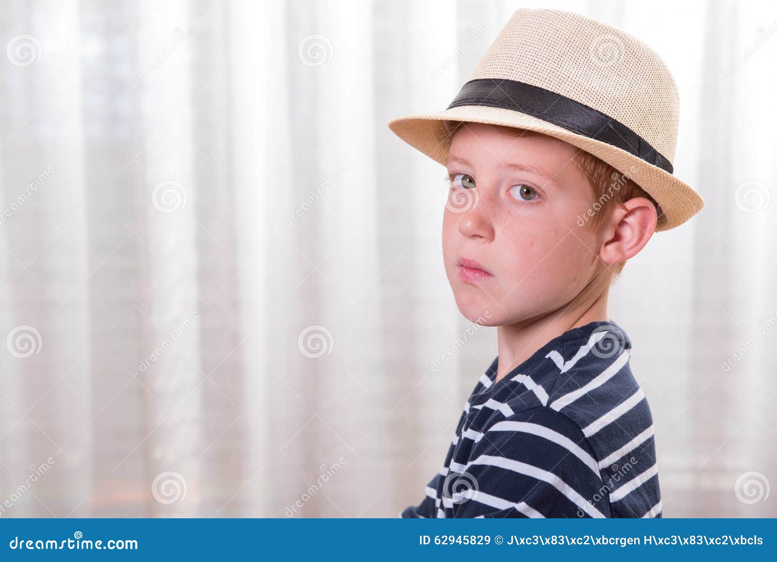 Young Boy with Hat Looking Angry into the Camera Stock Image - Image of ...