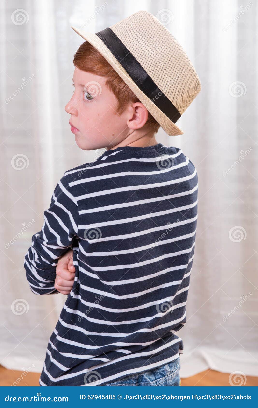 Young Boy with Hat Looking Over His Shoulder Stock Image - Image of ...