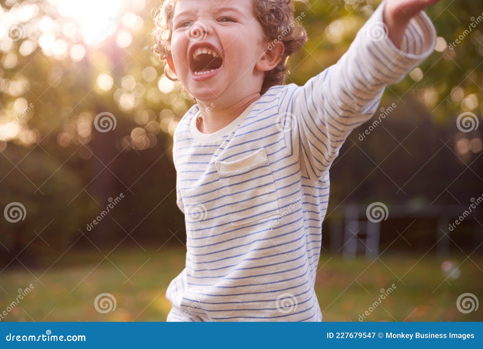 Young Boy Having Fun in Garden Chasing and Bursting Bubbles Stock Image ...