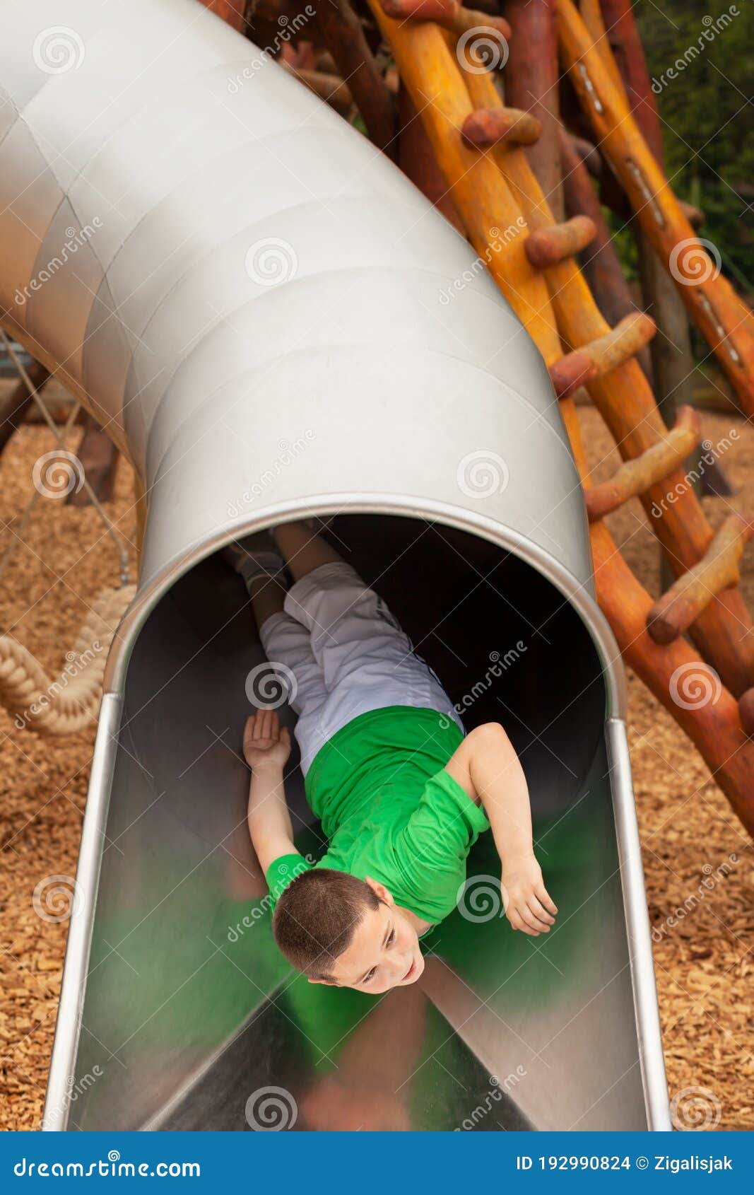 Young Boy Sliding Down a Slide in a Park Stock Photo - Image of ...