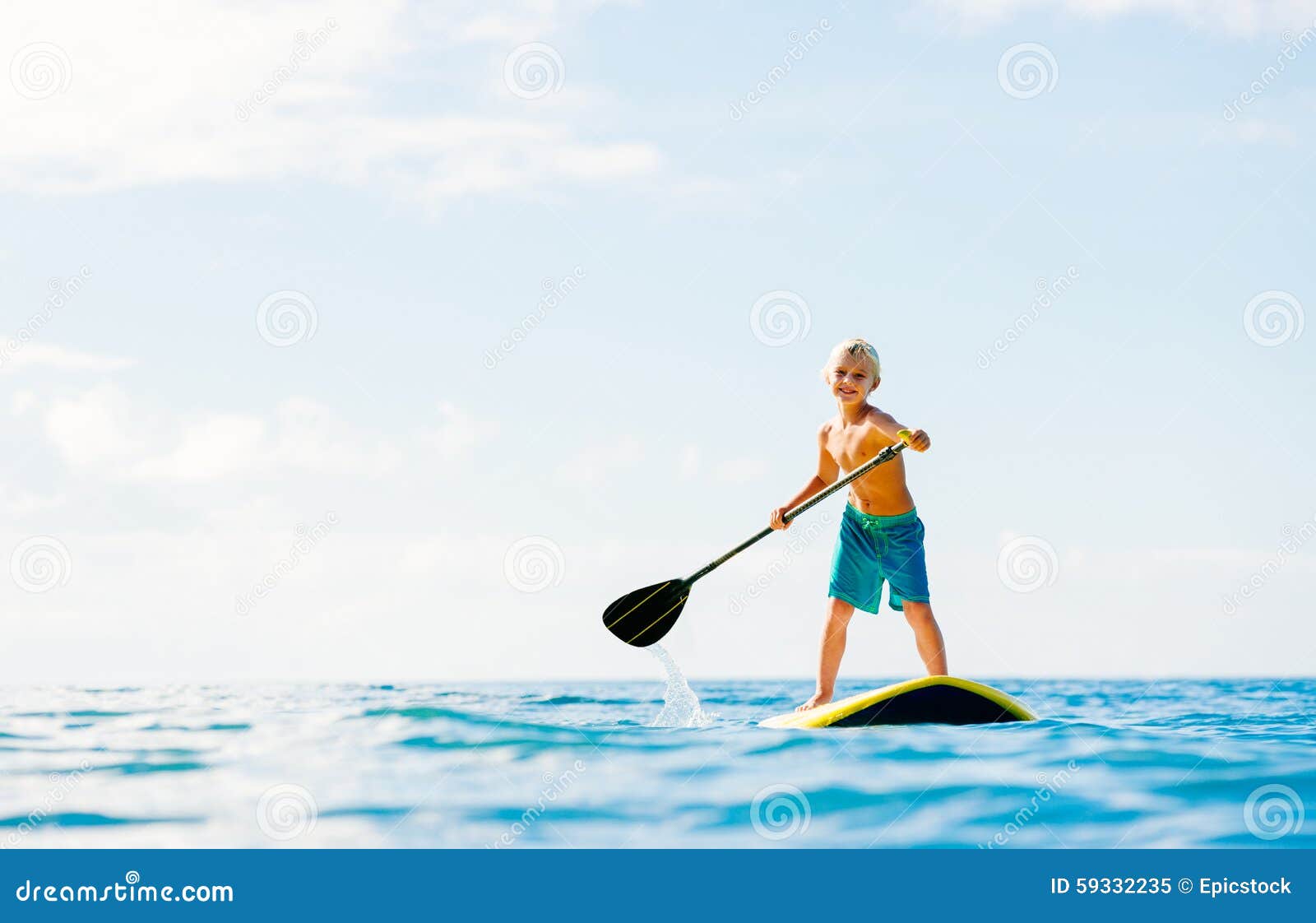 Young Boy Paddling A Kayak At The Beach On Vacation Stock Photo ...