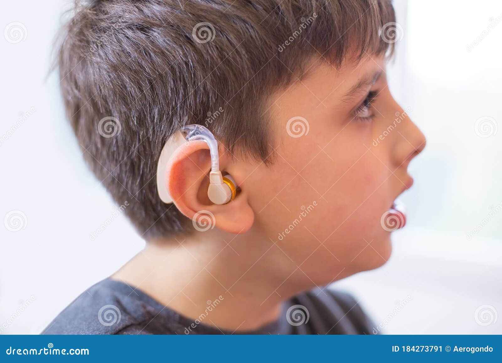 Young boy with hearing aid stock image. Image of male - 184273791