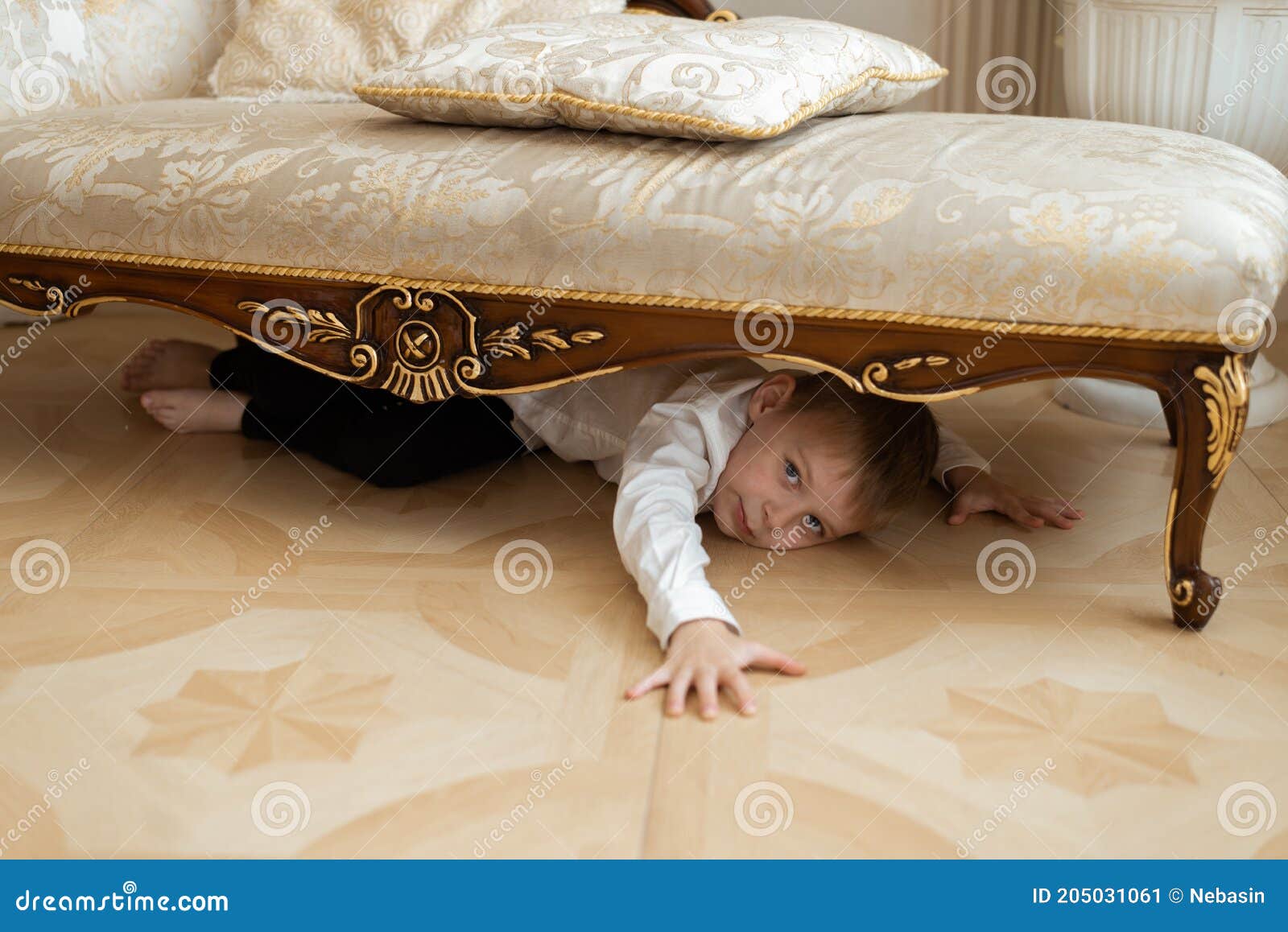 A Young Boy is Hiding Under the Sofa Stock Image - Image of innocence ...
