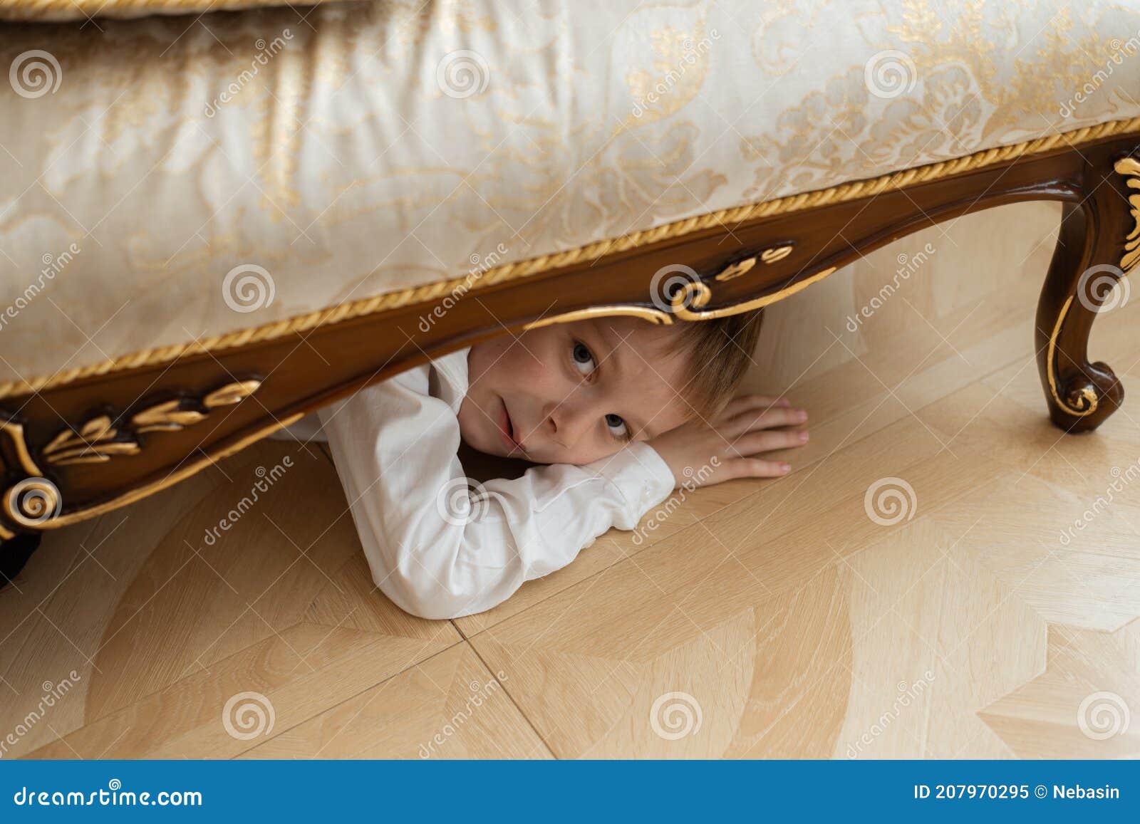 A Young Boy is Hiding Under the Sofa Stock Image - Image of home, blond ...