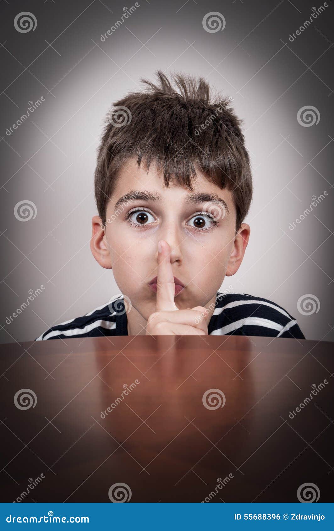 Young Boy Holding a Index Finger on His Lips Stock Photo - Image of ...