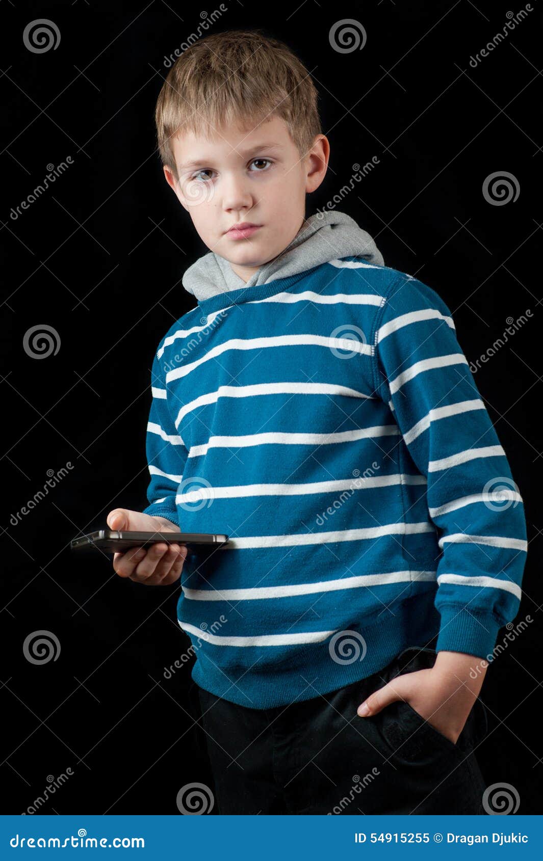 Young Boy Holding Mobile Phone Stock Image - Image of hands, standing ...