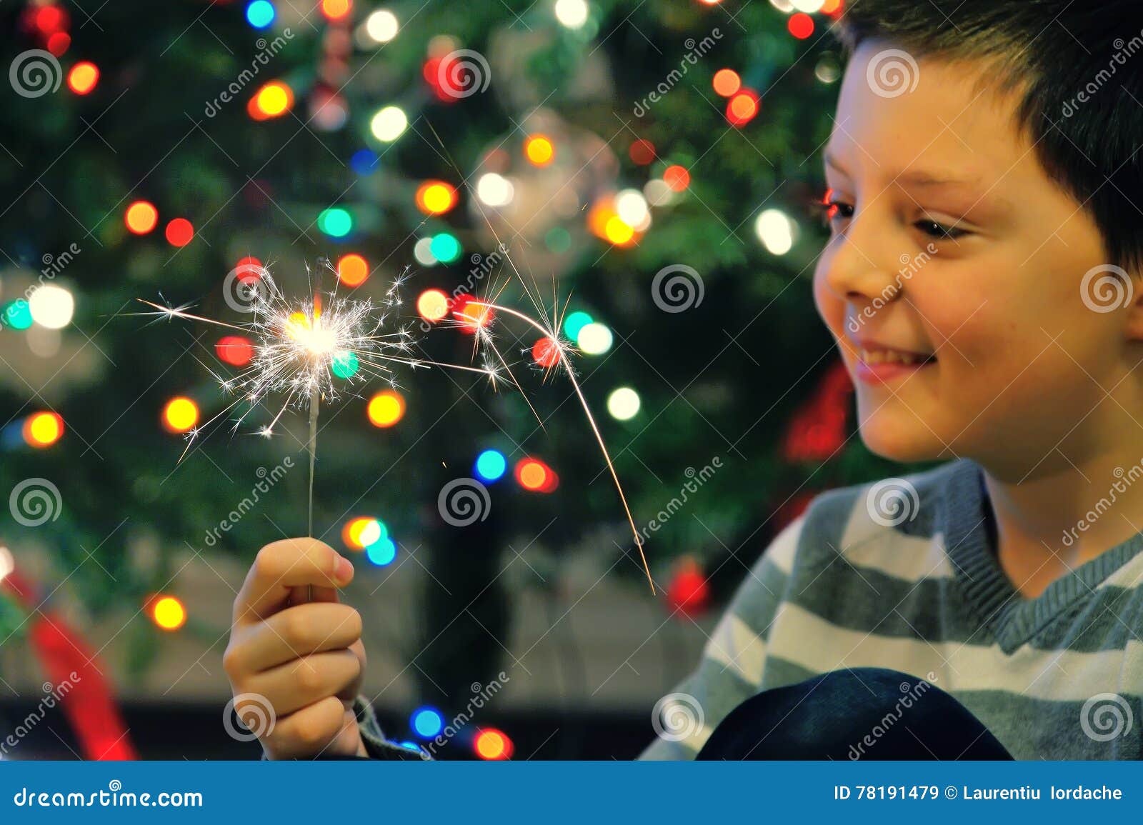 Young boy holding sparkler stock image. Image of joyful - 78191479