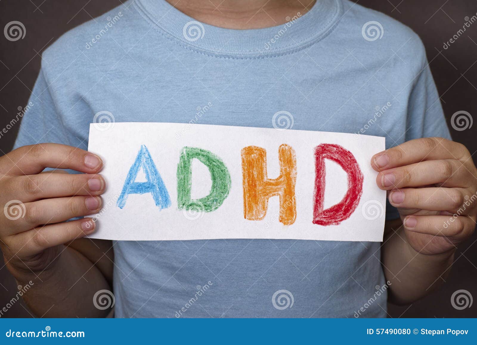 Young Boy Holds ADHD Text Written on Sheet of Paper Stock Photo - Image ...