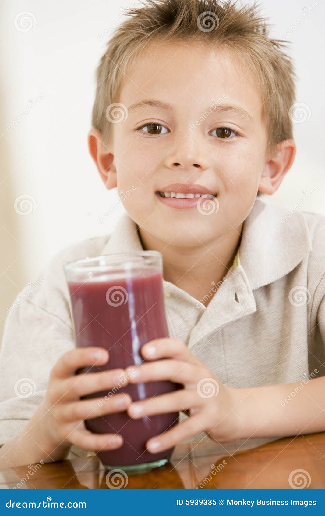 Young Boy Indoors Drinking Juice Stock Image - Image of looking ...