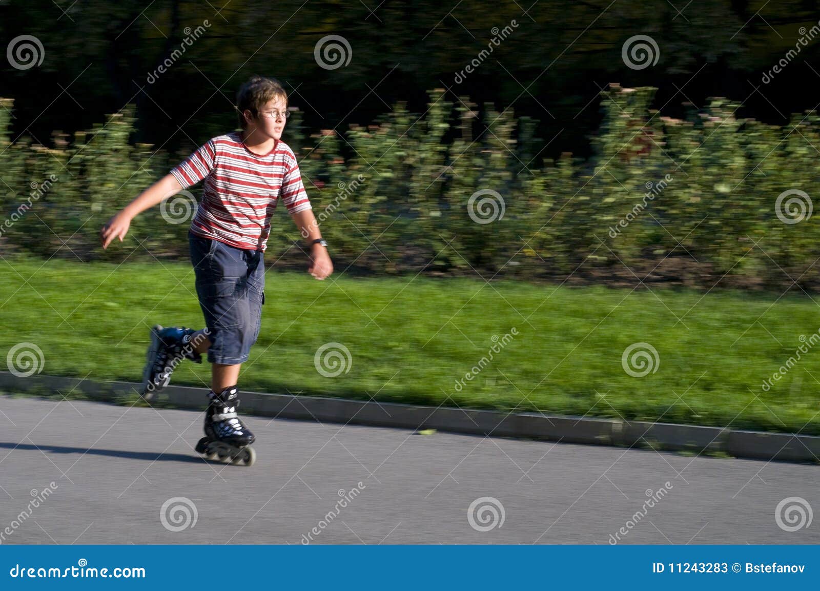 Young boy inline skating stock image. Image of outside - 11243283