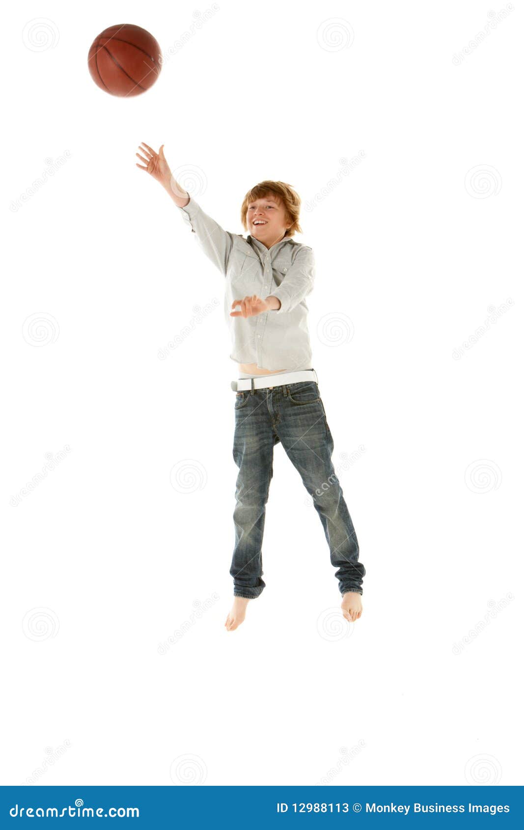 Young Boy Jumping with Basketball in Studio Stock Image - Image of ...