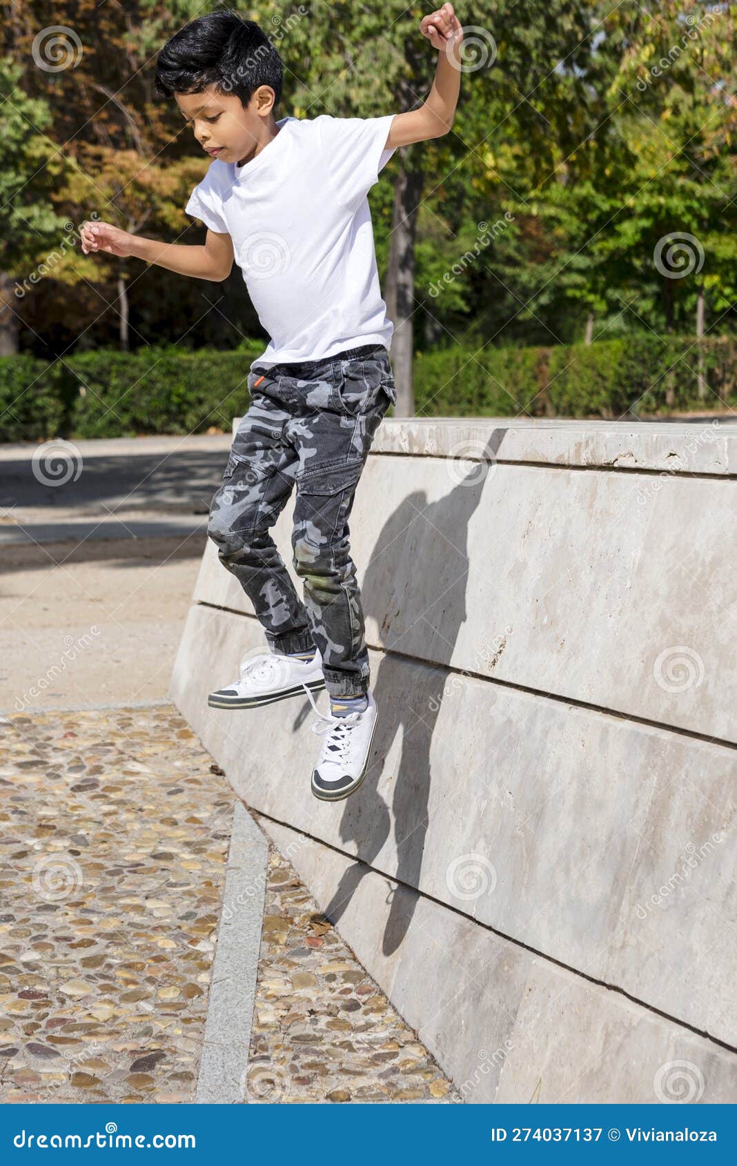 Young Boy Jumping while Having Fun in a Park. Stock Image - Image of ...