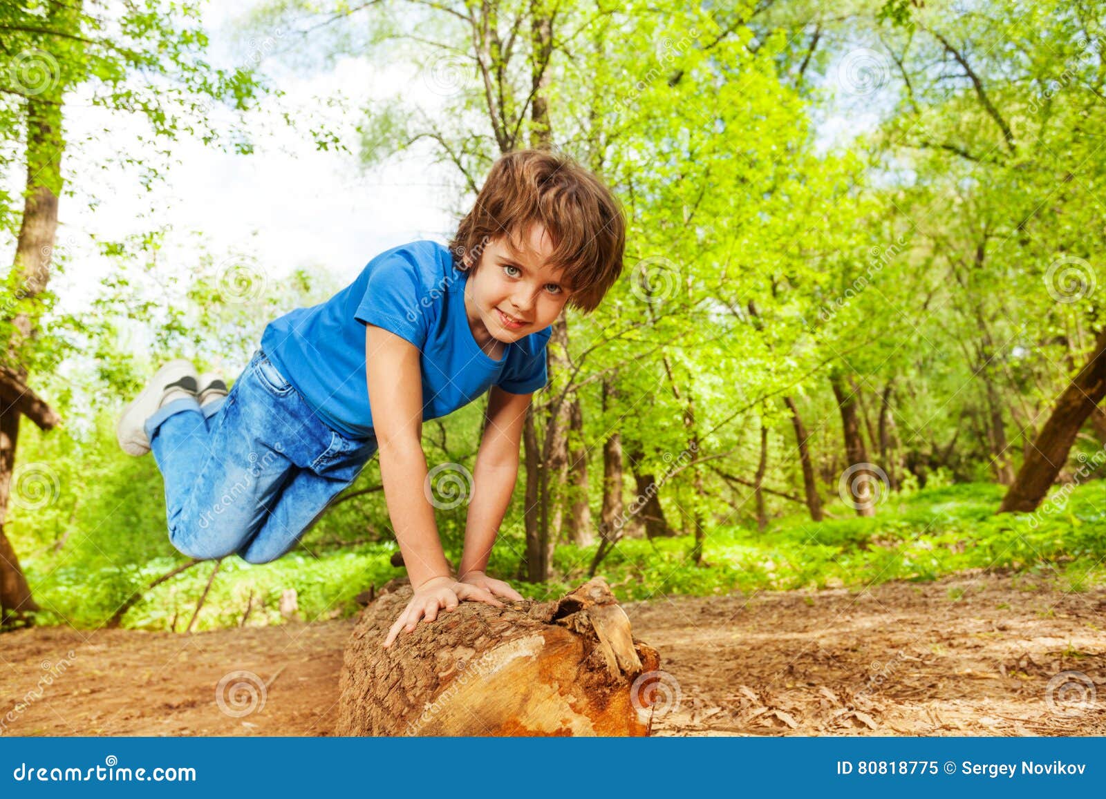 Young Boy Jumping Over the Log in Summer Forest Stock Image - Image of ...