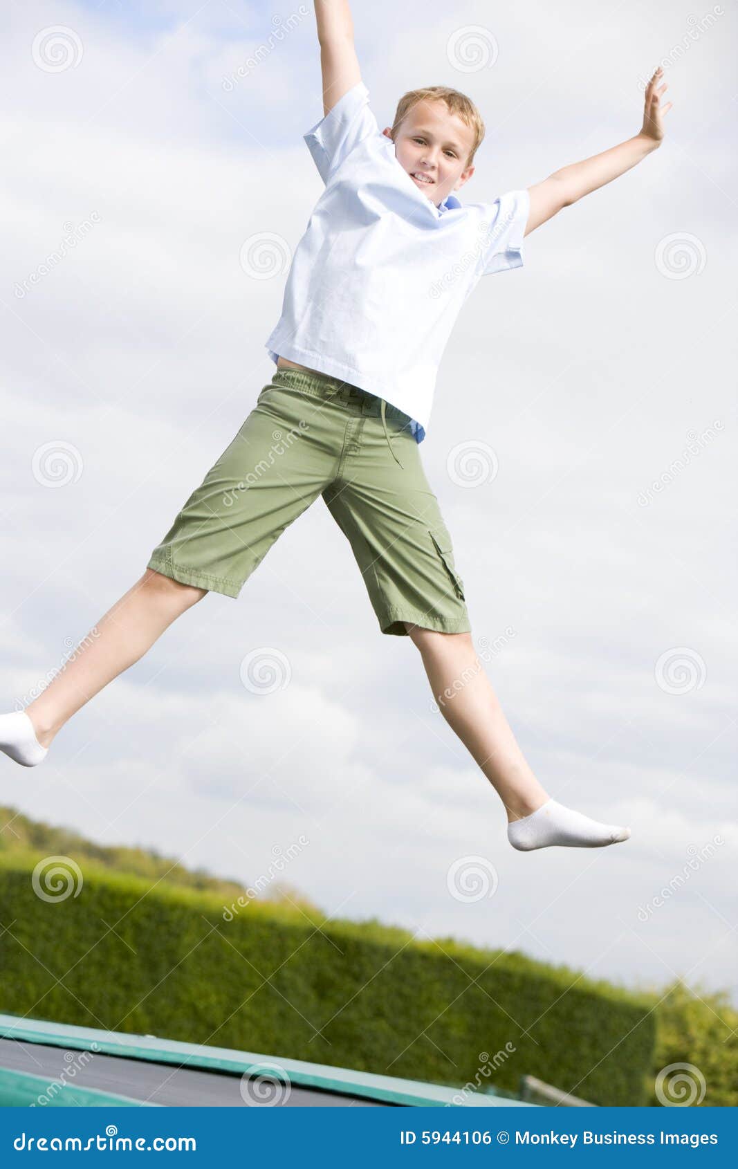 Young Boy Jumping on Trampoline Smiling Stock Photo - Image of portrait ...