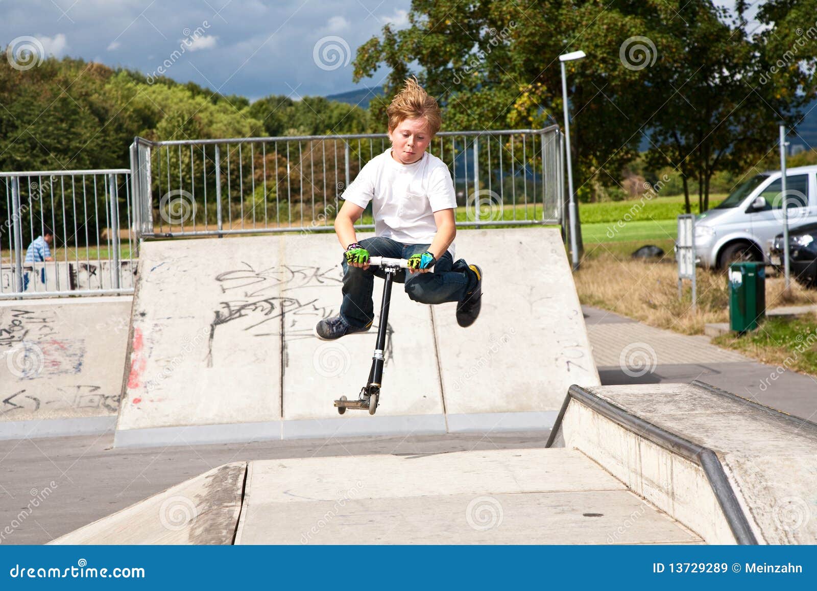 Young Boy Jumps with Scooter Over a Ramp at the Sk Stock Image - Image ...