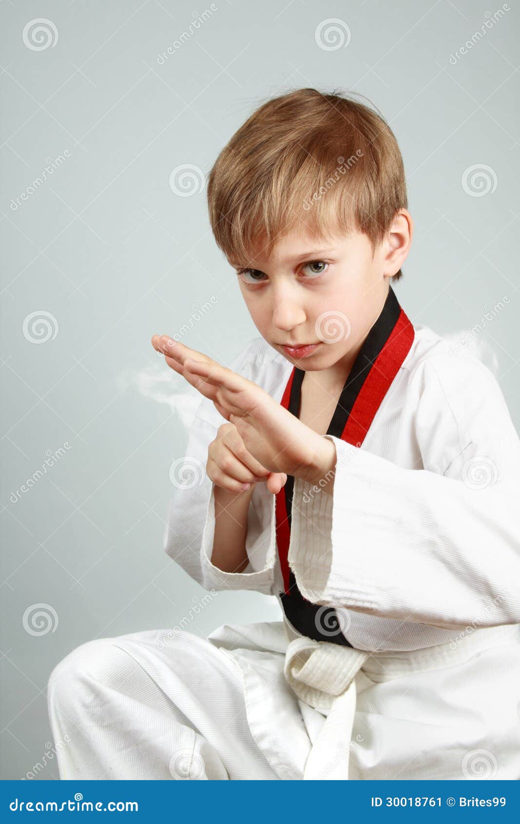 Young Boy In A Karate Suit Practicing Martial Arts Looking Menacing ...